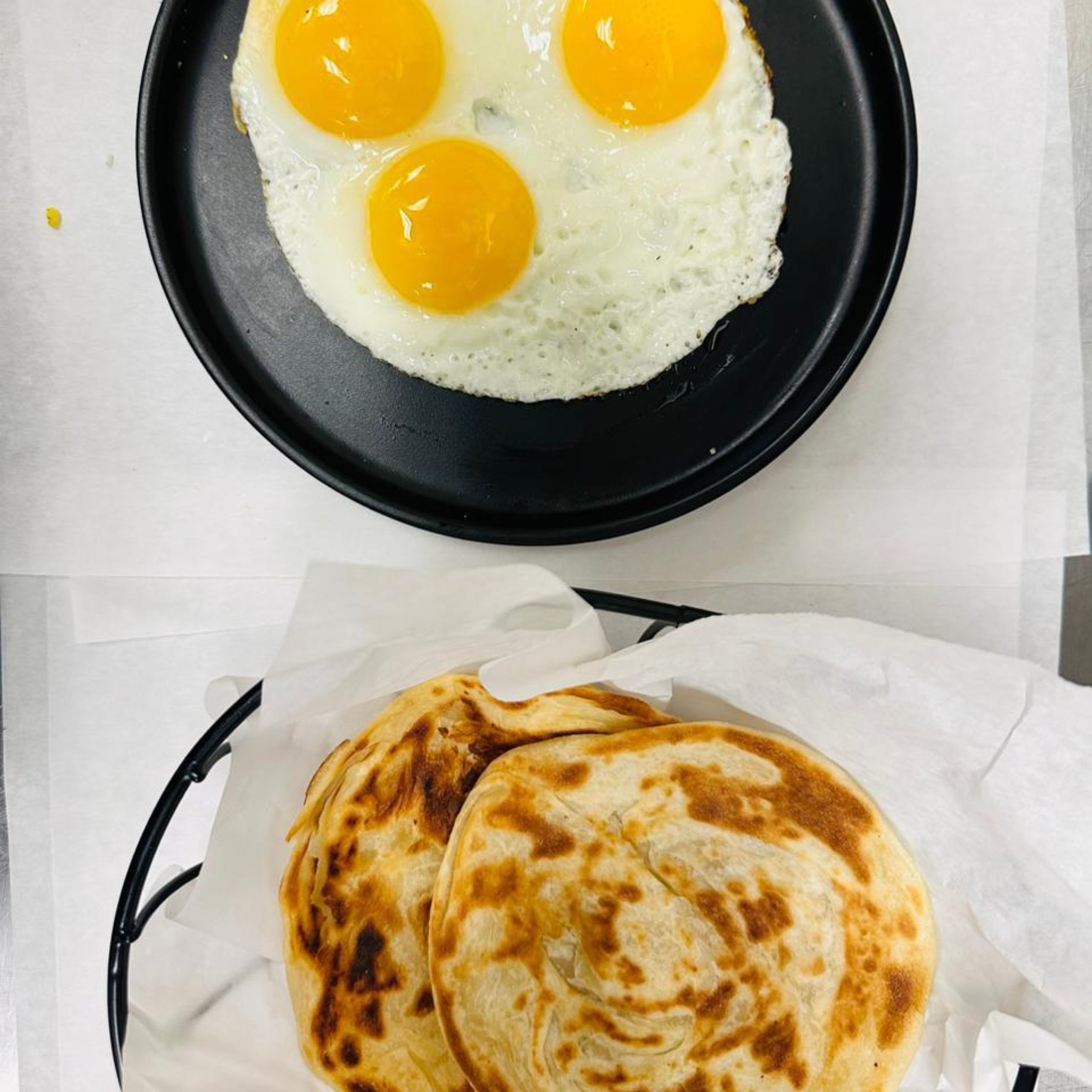 Eggs sunny side up with paratha | Kanishka Cuisine of India